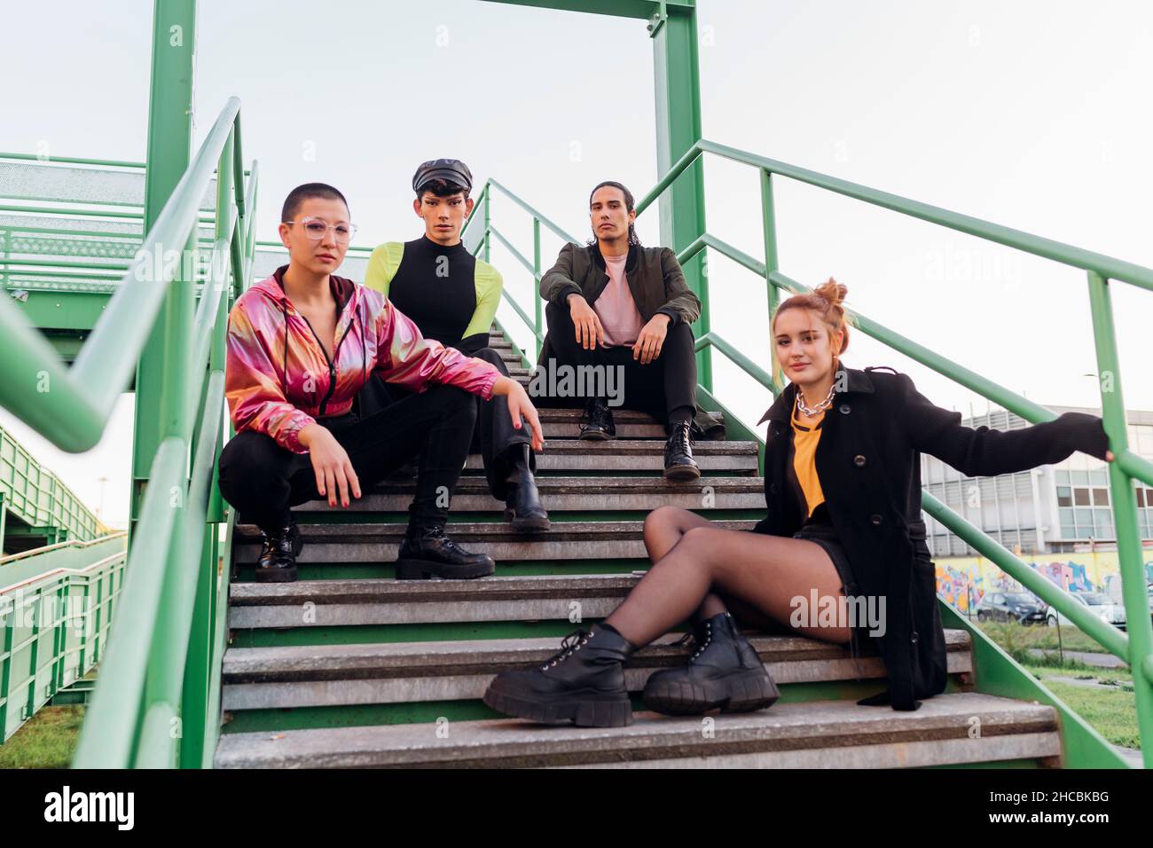 Woman sitting with friends on staircase Stock Photo - Alamy