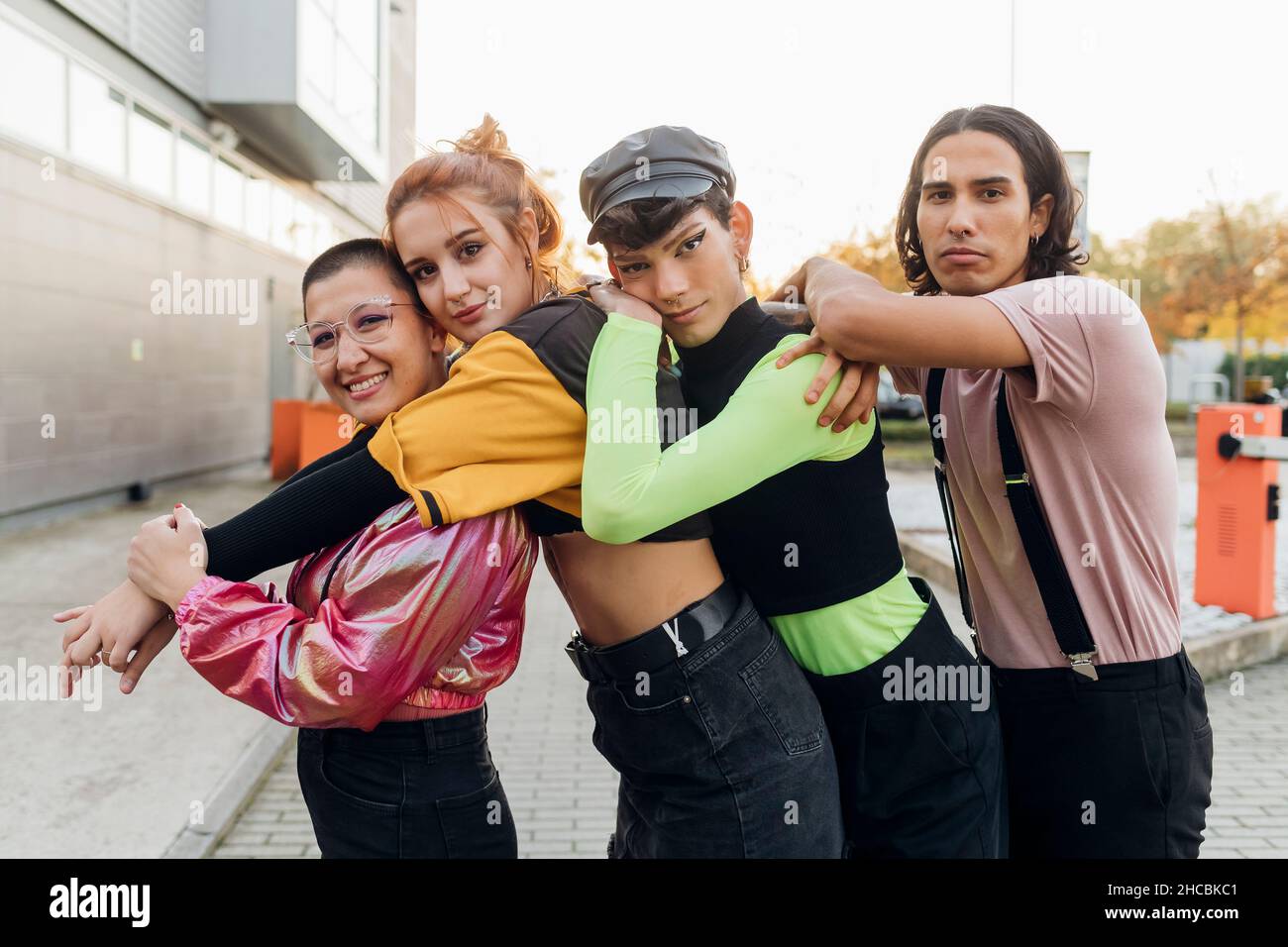 Friends standing in line on footpath Stock Photo - Alamy