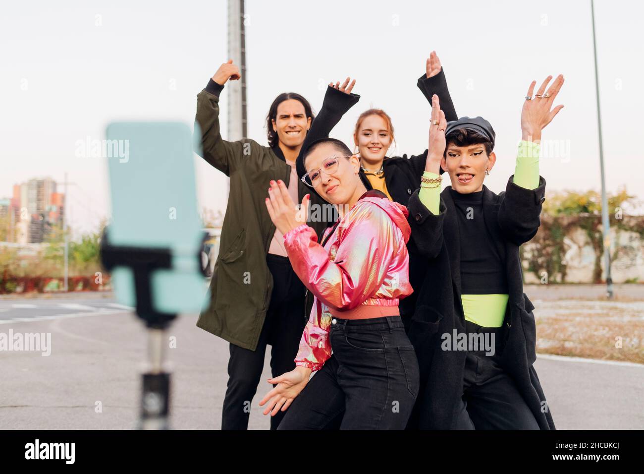 Friends filming dance through mobile phone on tripod Stock Photo - Alamy