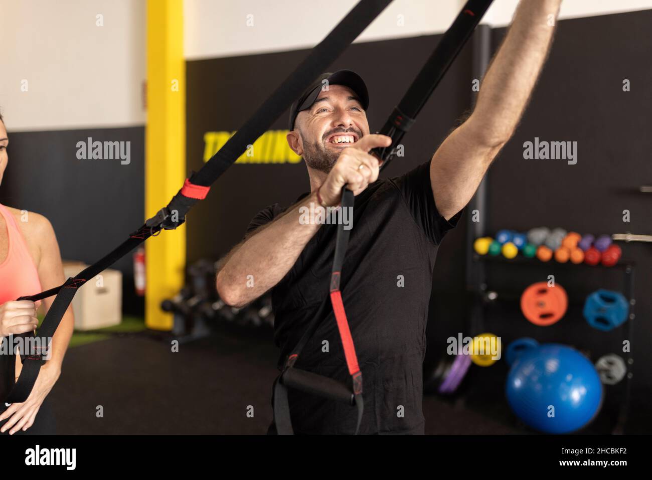 Confident fitness coach instructing in gym Stock Photo - Alamy