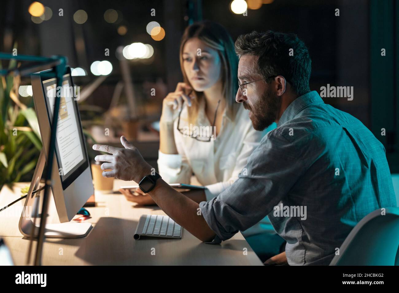 Business people pointing at monitor hi-res stock photography and images ...