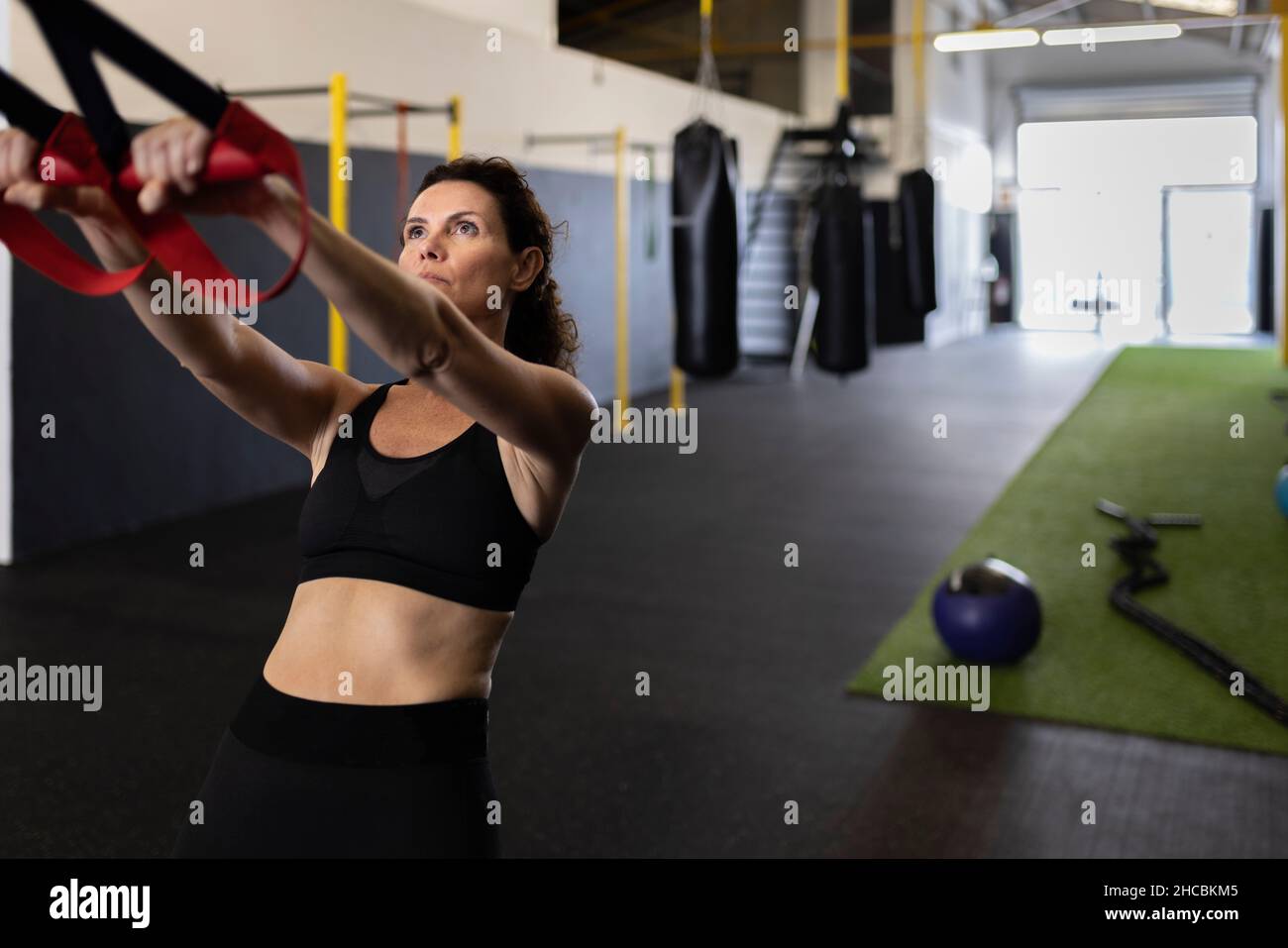 Fitness coach instructing athlete in gym Stock Photo - Alamy