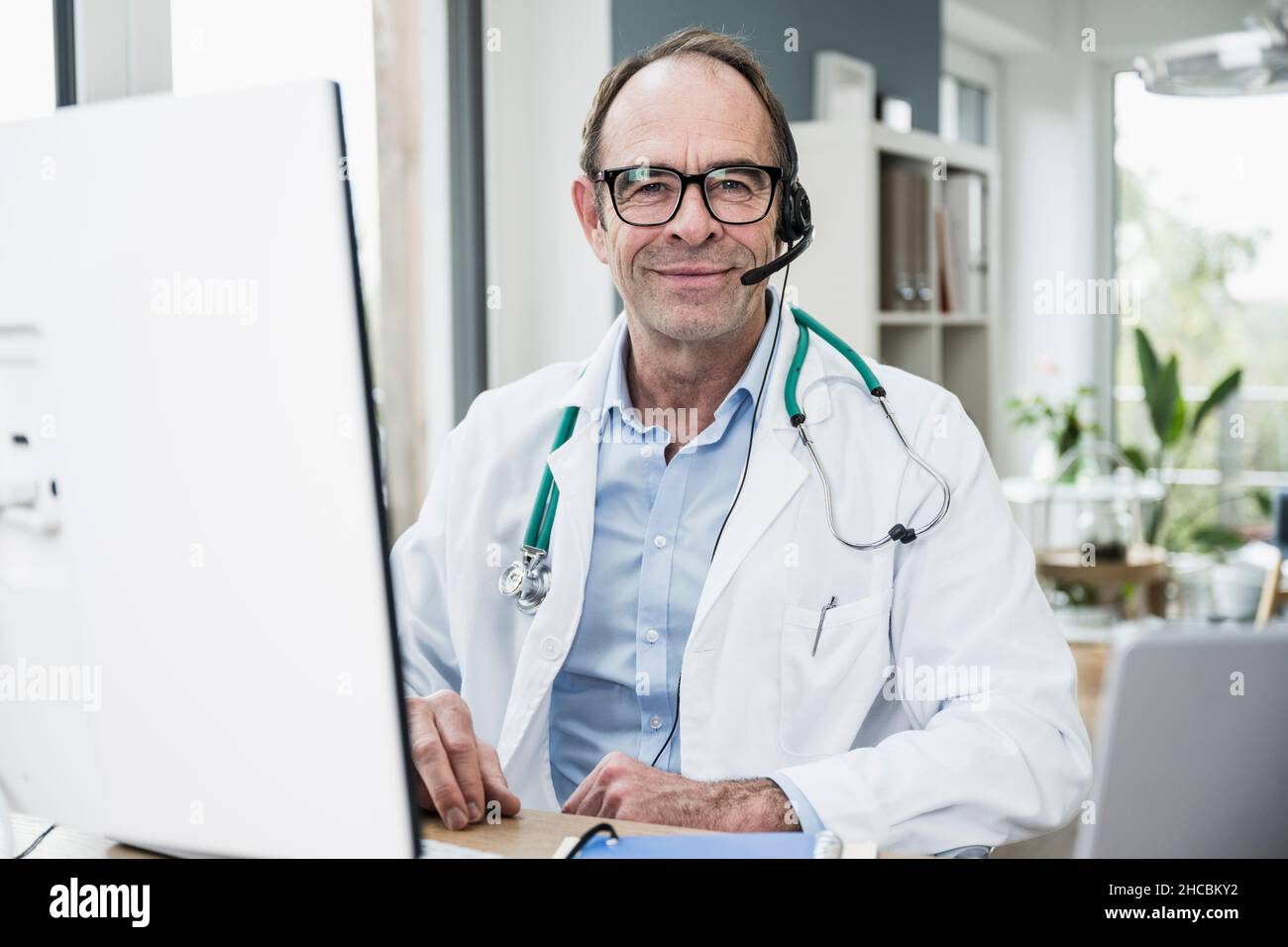 Doctor with computer looking at camera hi-res stock photography and ...