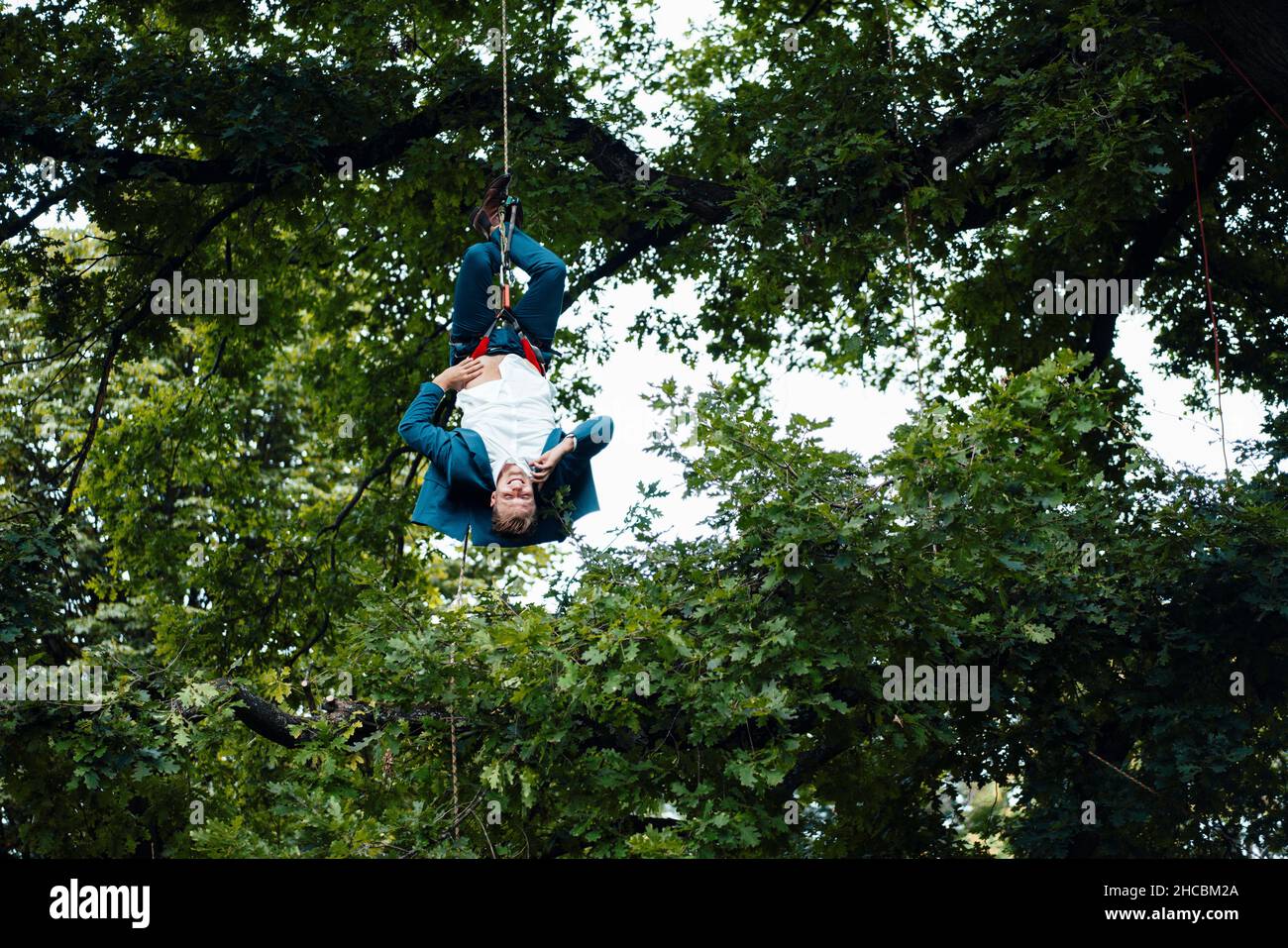 Man hanging tree branch hi-res stock photography and images - Alamy