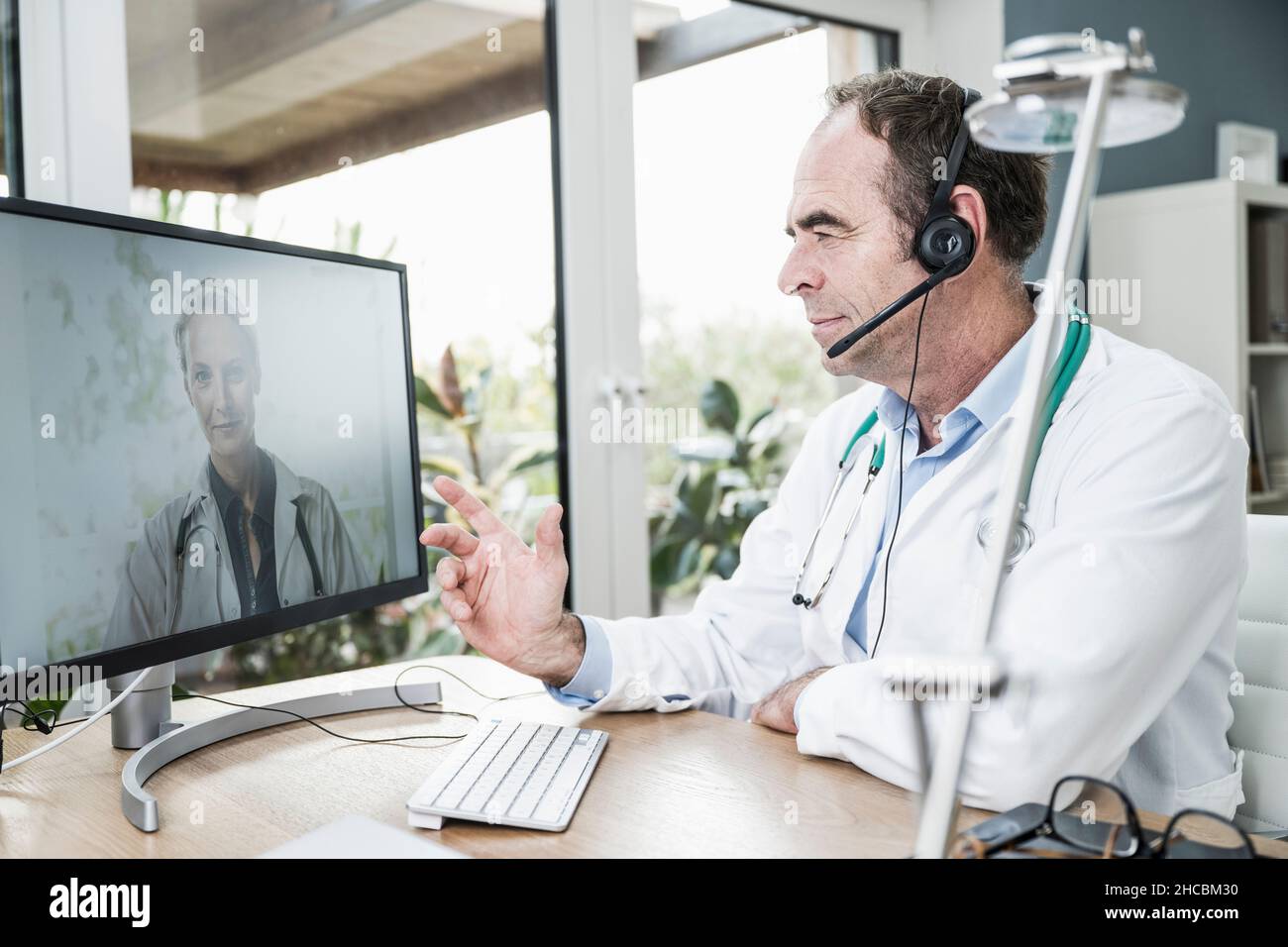 Doctor wearing headset discussing hi-res stock photography and images ...