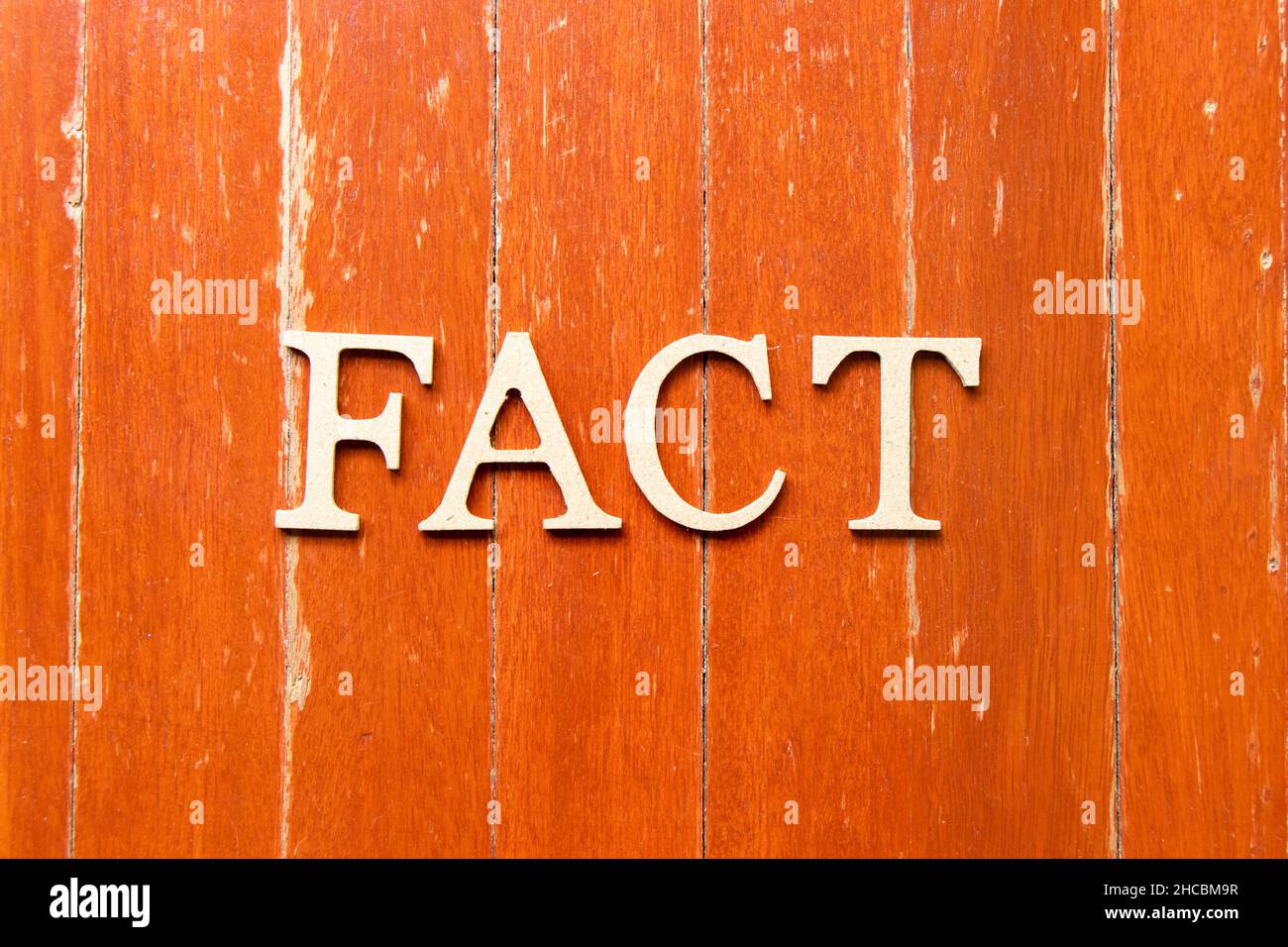 Alphabet letter in word fact on old red color wood plate background ...
