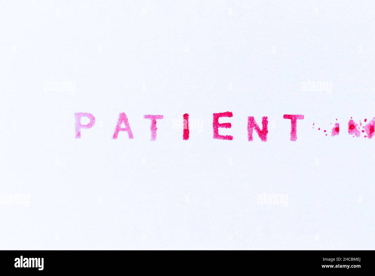 Red color ink rubber stamp in word patient on white paper background ...