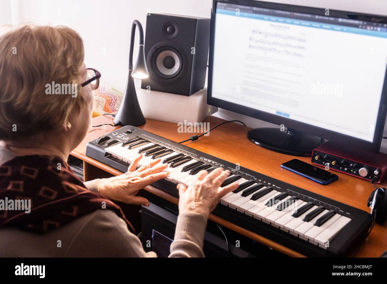 Elderly woman playing the keyboard Stock Photo - Alamy