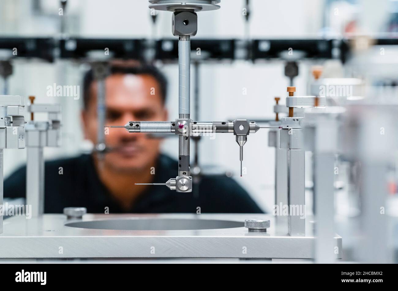 Engineer examining automated machine in industry Stock Photo - Alamy