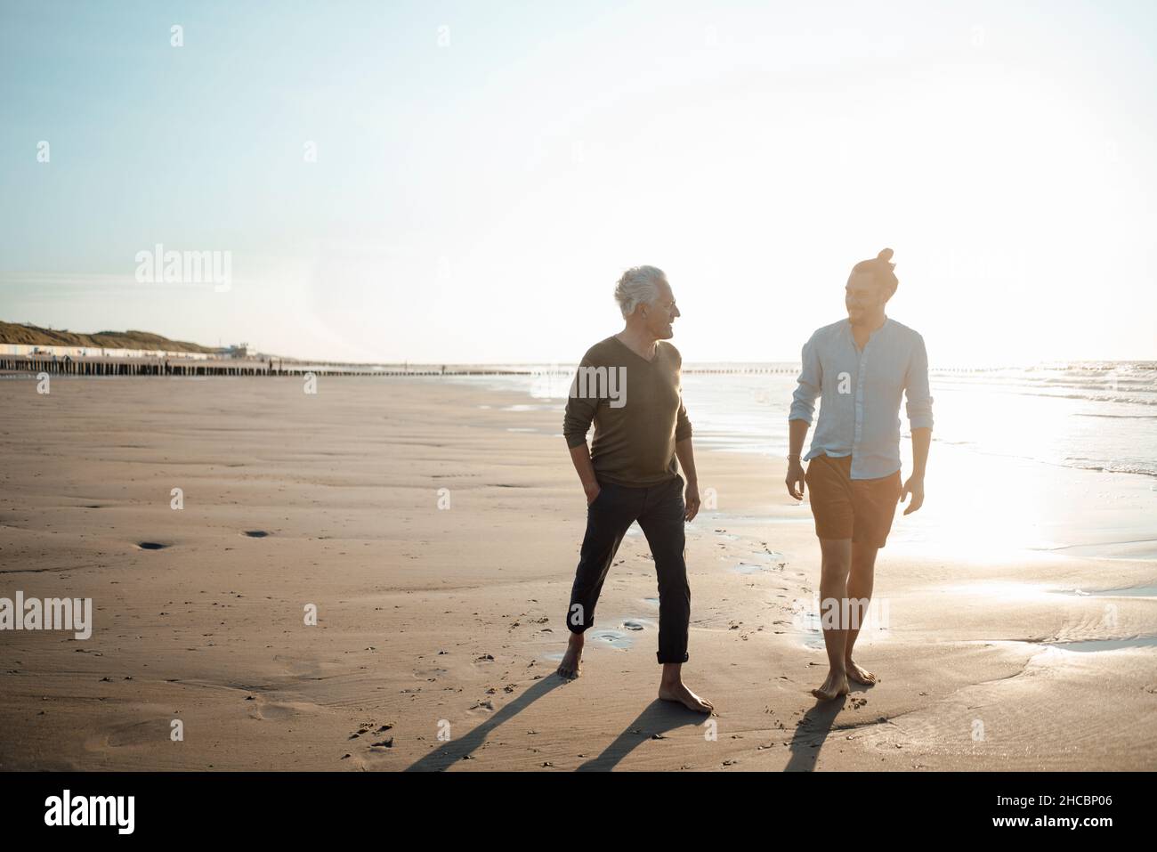 Senior man walking on sand at beach Stock Photo - Alamy