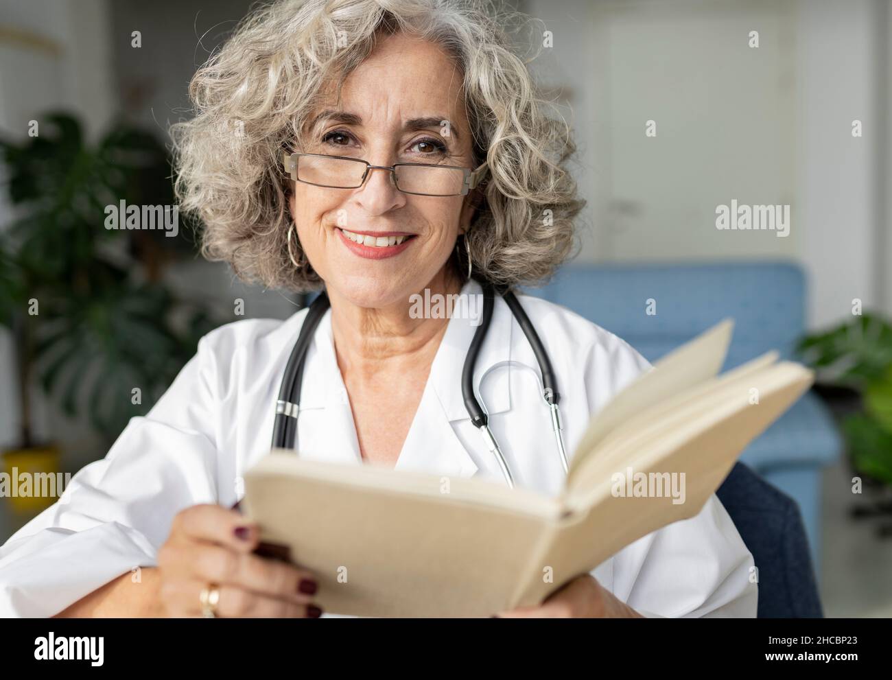 Senior senior doctor reading diary at home office Stock Photo - Alamy