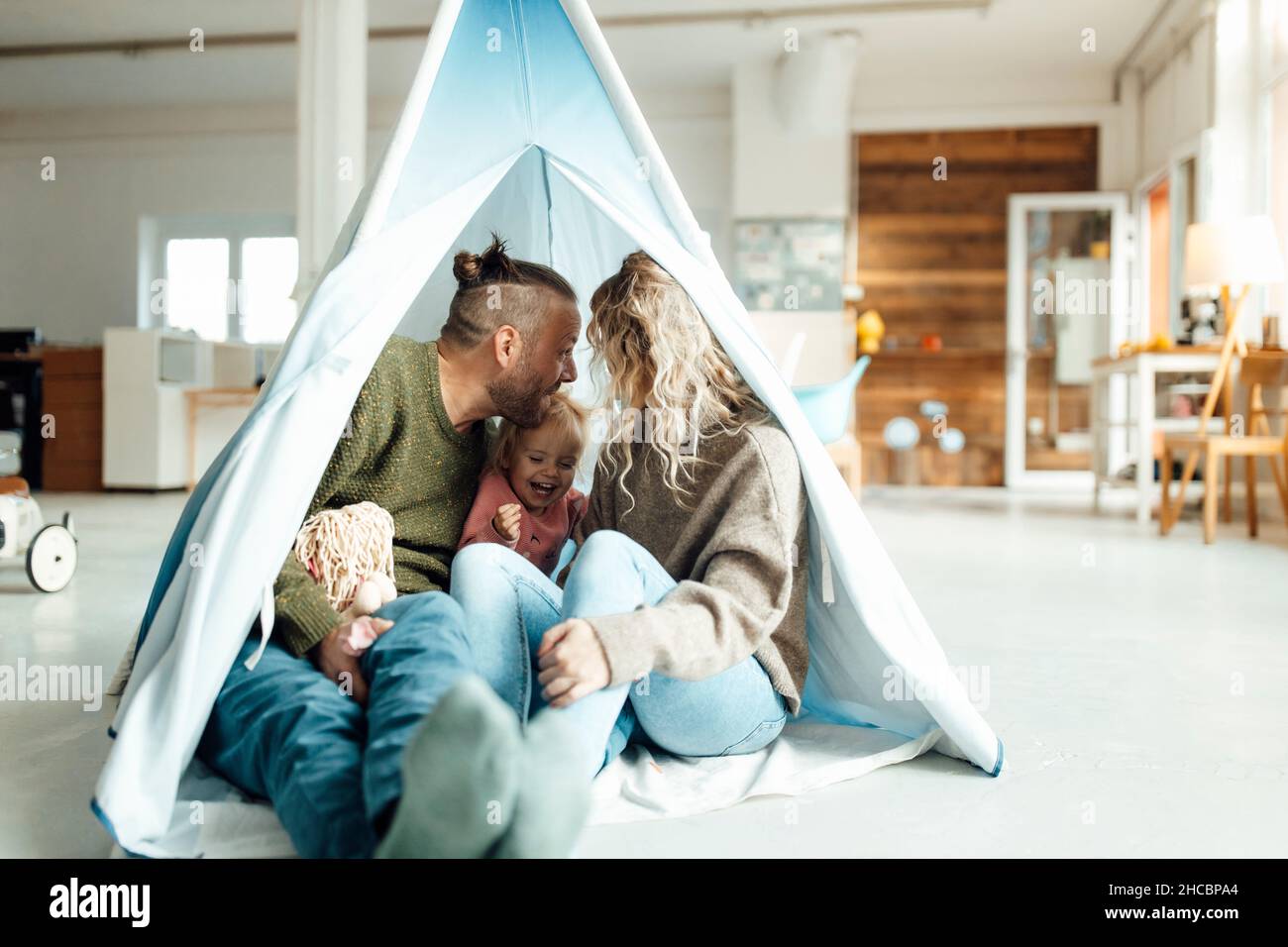Playful family enjoying inside tent at home Stock Photo - Alamy