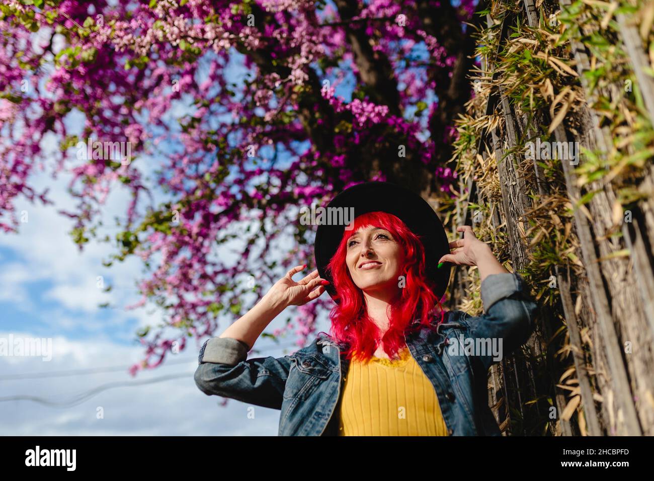 Woman adjusting hat near hi-res stock photography and images - Alamy