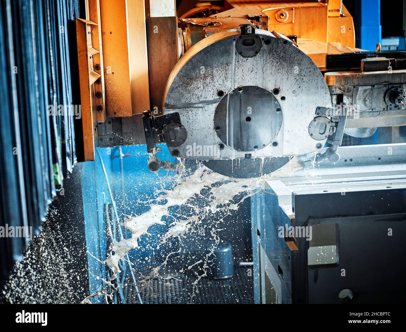 CNC machine splashing water while cutting material inside modern ...