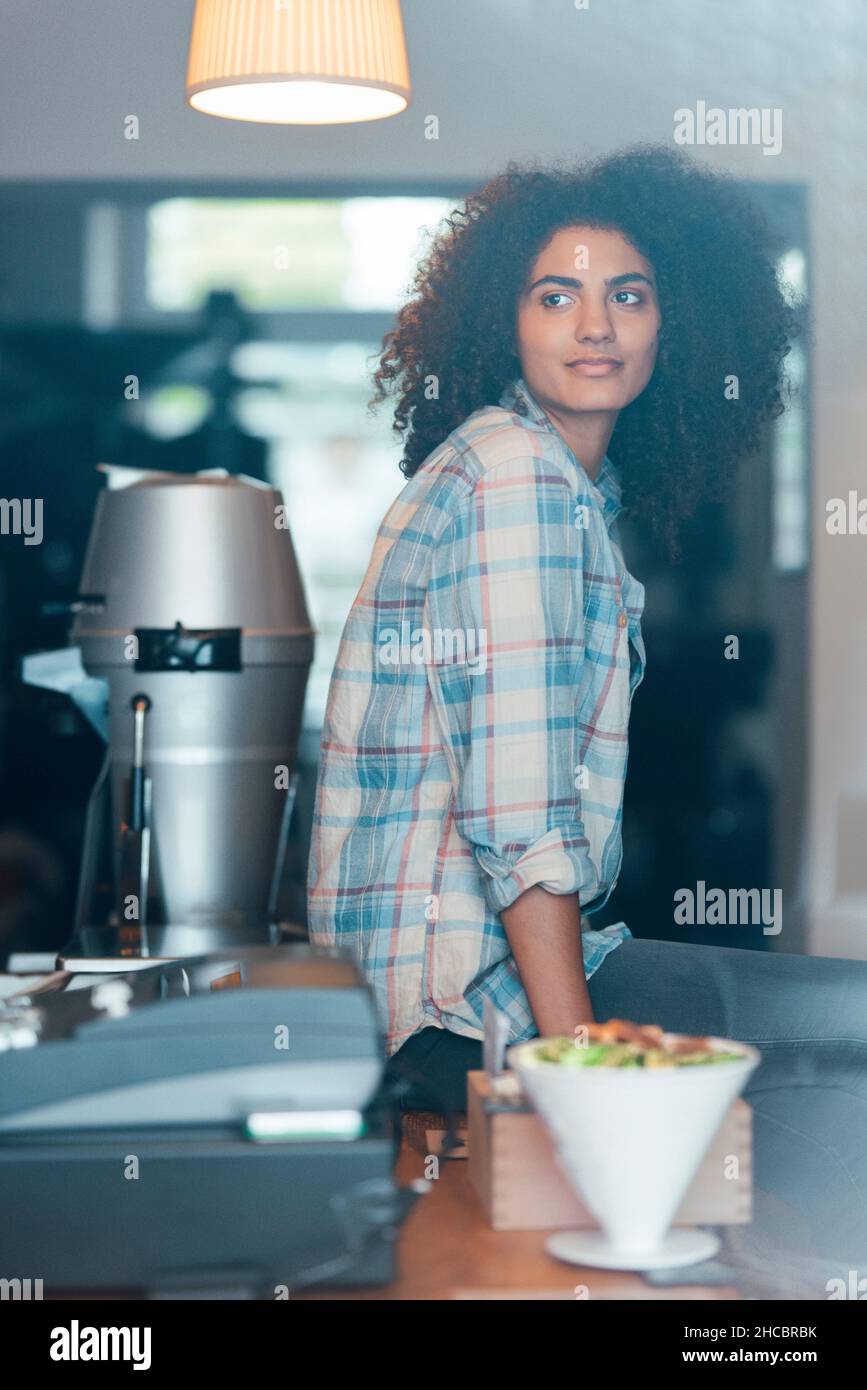 Young owner contemplating in coffee roastery Stock Photo - Alamy