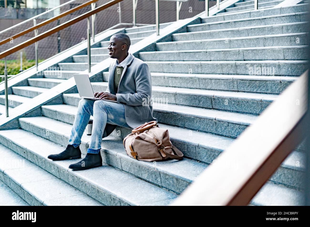 Man sitting side long coat hi-res stock photography and images - Alamy