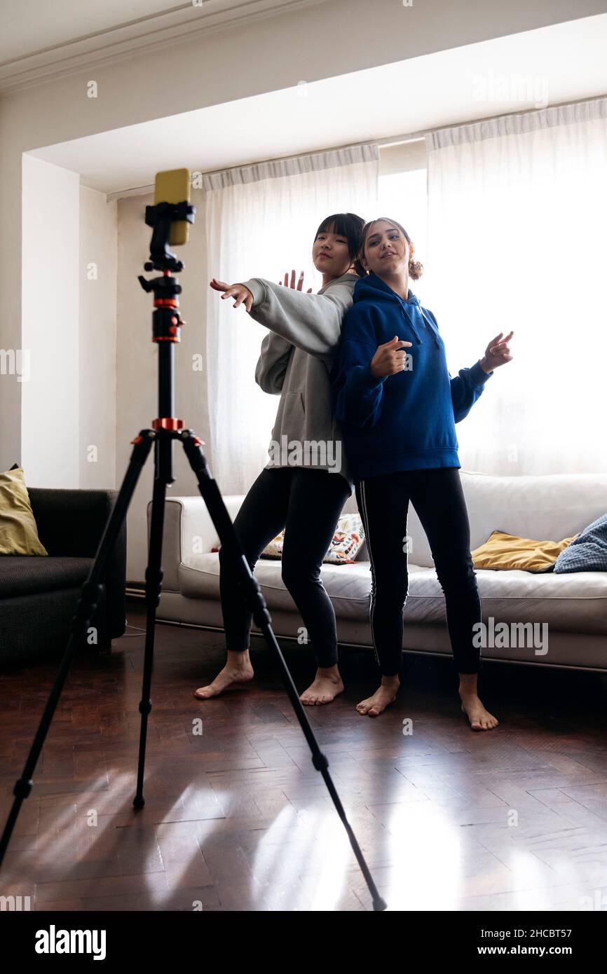 Friends filming dance through mobile phone at home Stock Photo - Alamy