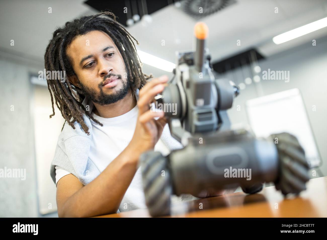 Technician examining robotic combat tank at workshop Stock Photo - Alamy