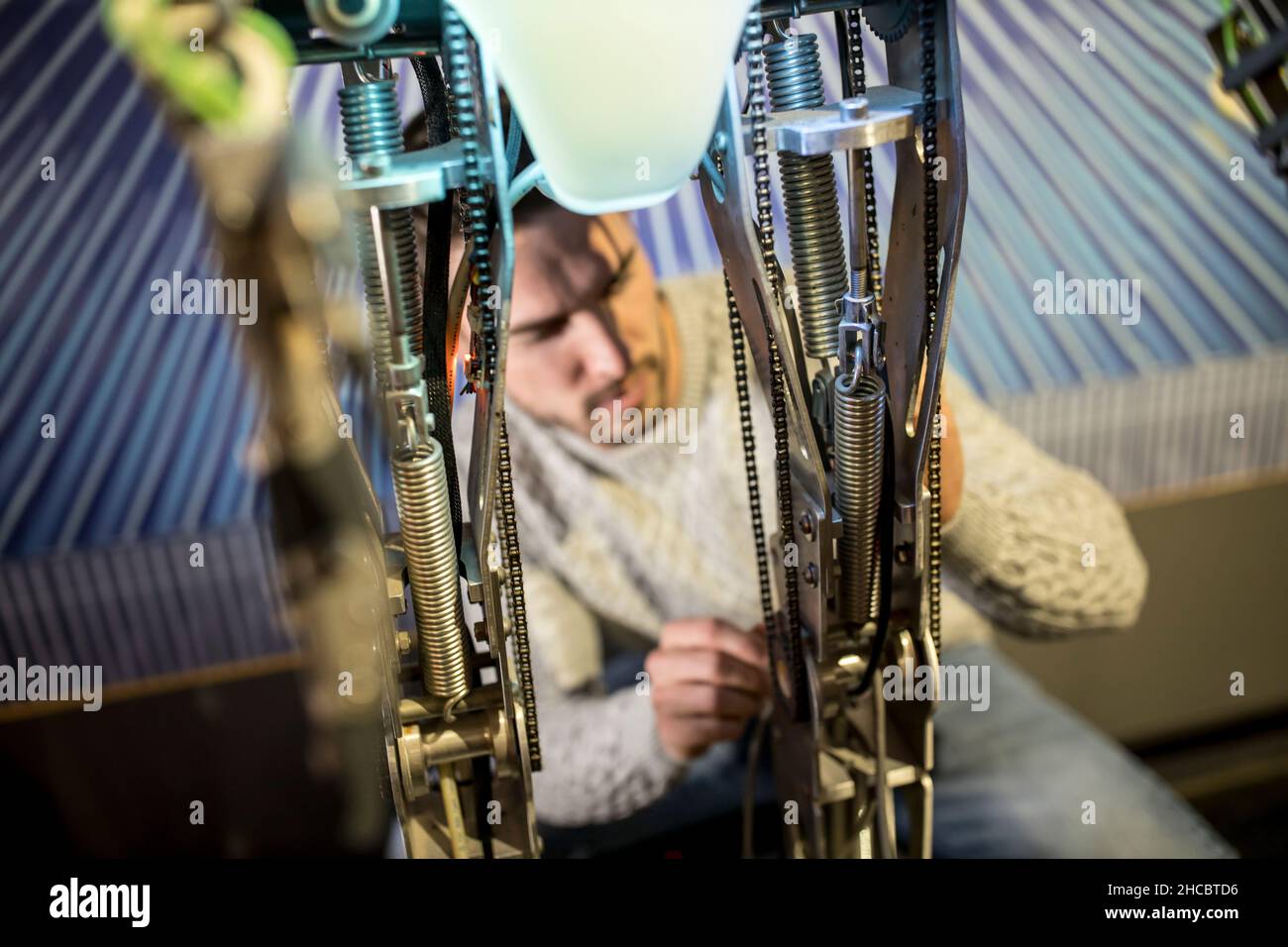 Engineer fixing machine part of human robot at workshop Stock Photo - Alamy