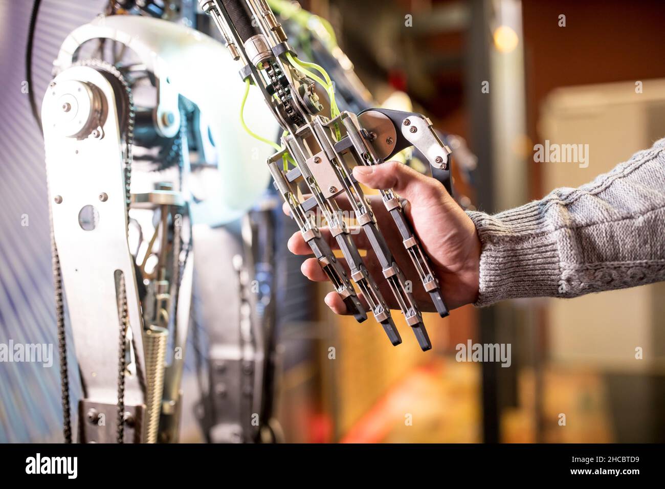 Engineer shaking hand with robotic arm at workshop Stock Photo - Alamy