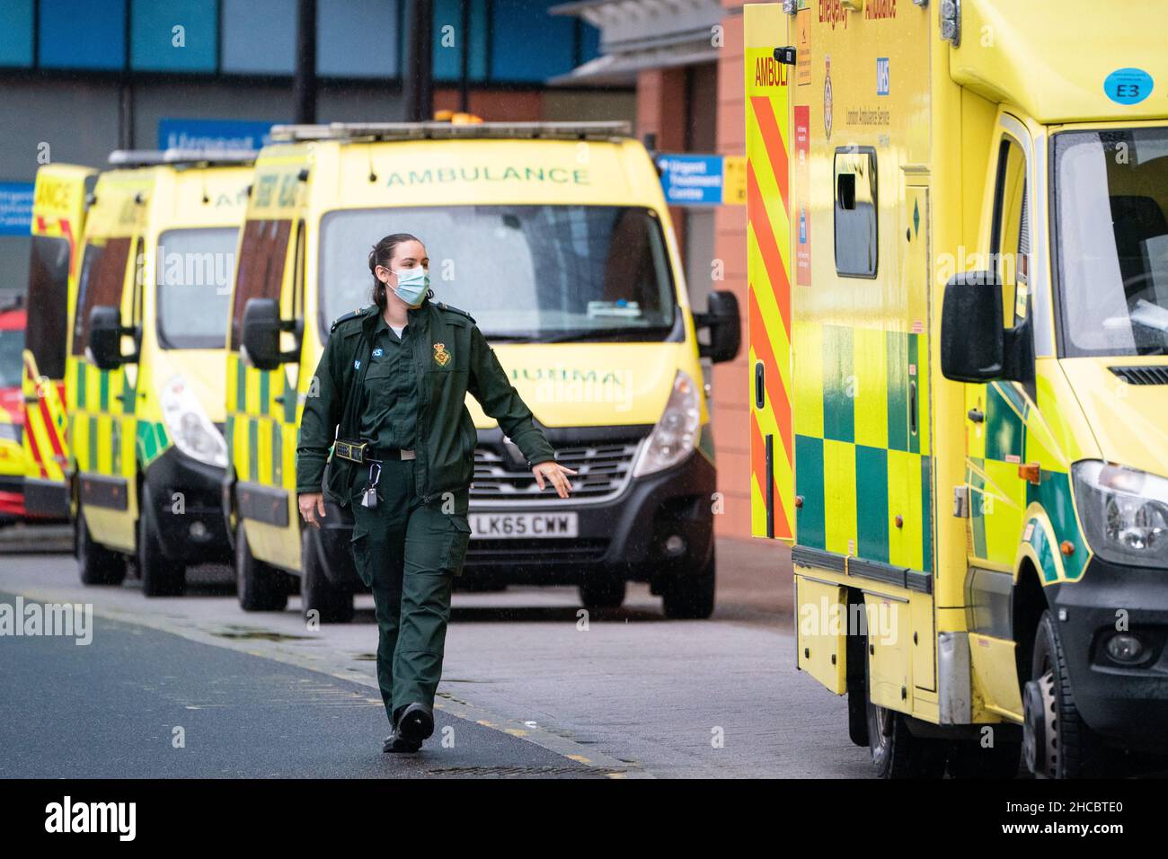 A paramedic walks past a line of ambulances outside the Royal London ...