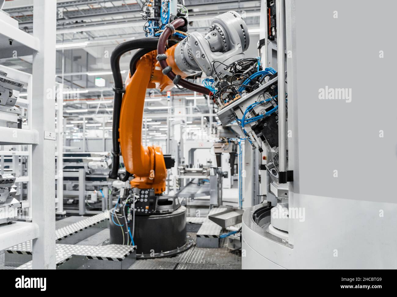 Orange robotic arm in automated factory Stock Photo - Alamy