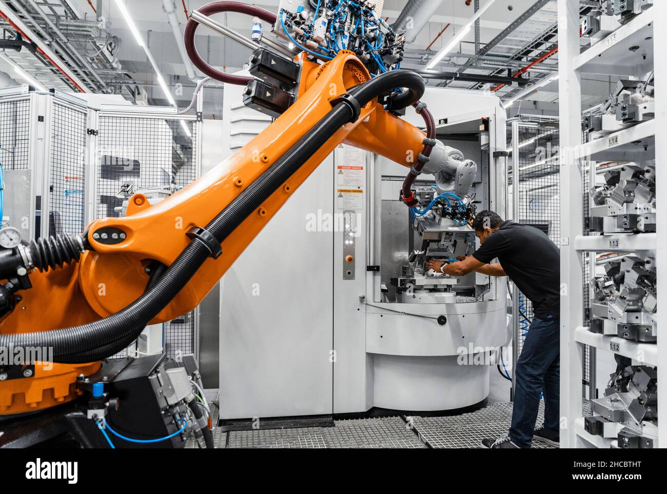 Maintenance engineer repairing robotic arm in industry Stock Photo - Alamy