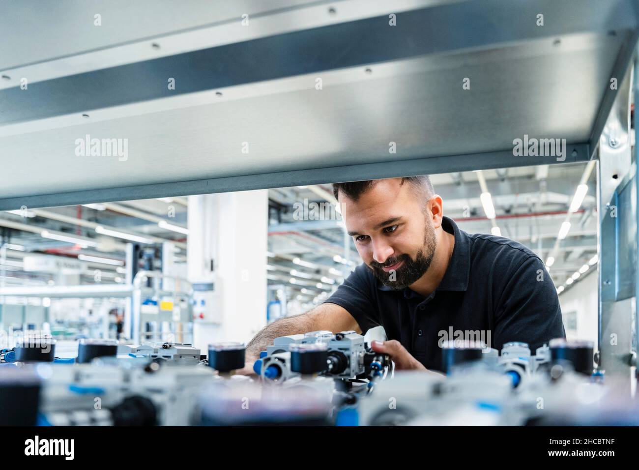 Engineer checking electrical equipment at automated industry Stock ...