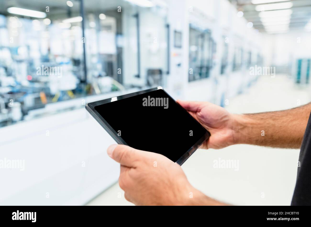 Engineer holding tablet PC at electrical industry Stock Photo - Alamy