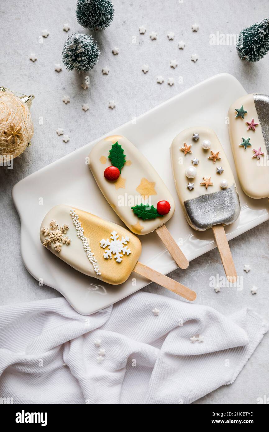 Hand of boy by Christmas Tree made from stacking cookies in plate on ...
