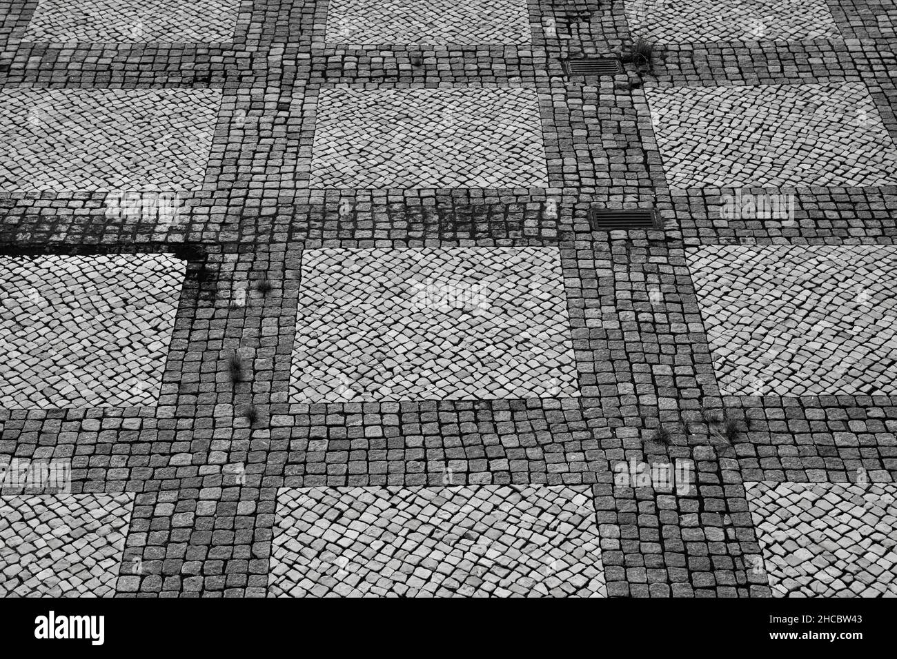 Checked pattern on paved surface Stock Photo - Alamy