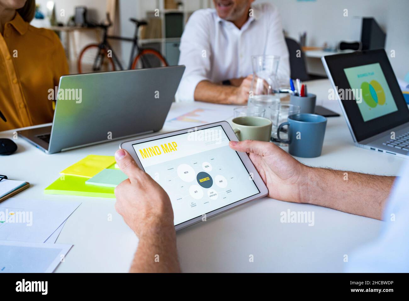 Businesswoman analyzing progress report through laptop at office Stock ...