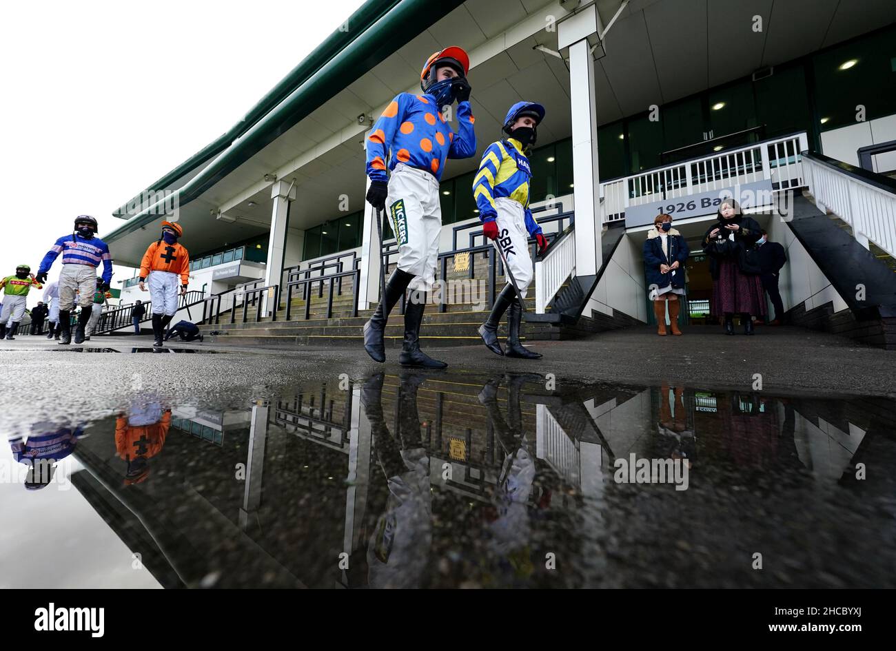 Jockeys make their way to the parade ring before the Coral Finale ...