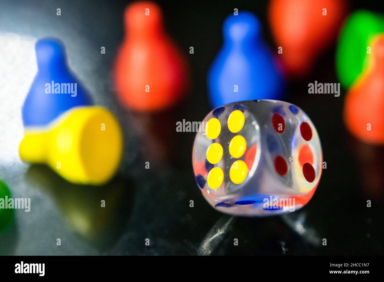 Photo of a clear dice and tokens in a reflective surface Stock Photo ...