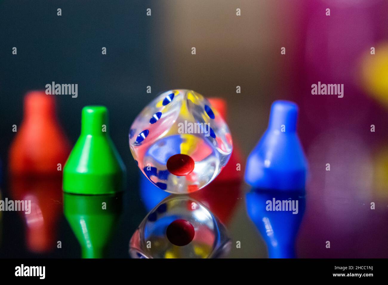 Photo of a clear dice and tokens in a reflective surface Stock Photo ...