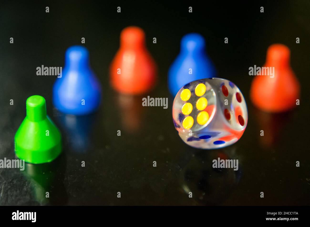 Photo of a clear dice and tokens in a reflective surface Stock Photo ...