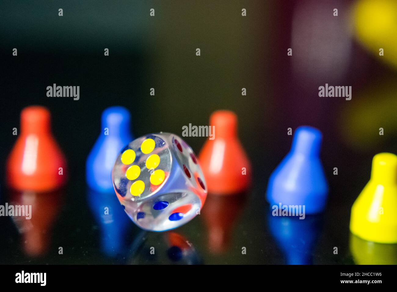 Photo of a clear dice and tokens in a reflective surface Stock Photo ...