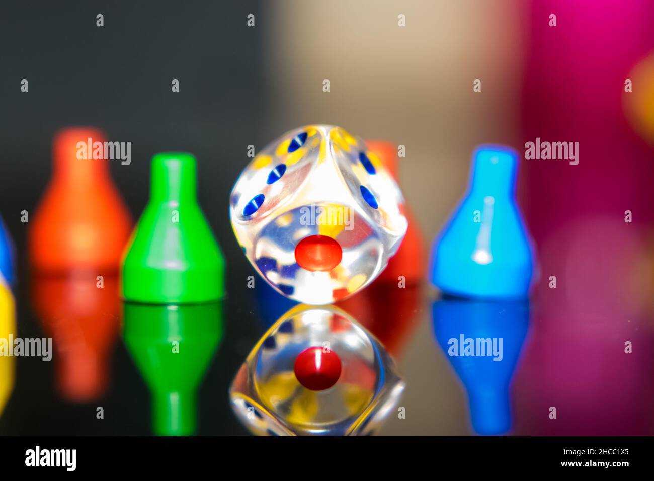 Photo of a clear dice and tokens in a reflective surface Stock Photo ...
