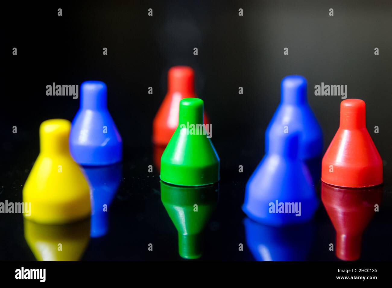Photo of a some colorful token in a reflective surface Stock Photo - Alamy