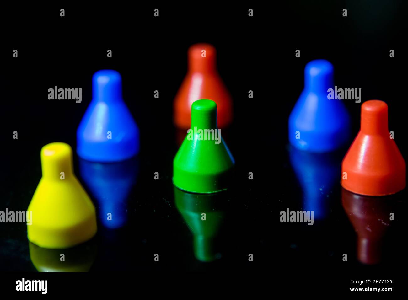 Photo of a some colorful token in a reflective surface Stock Photo - Alamy