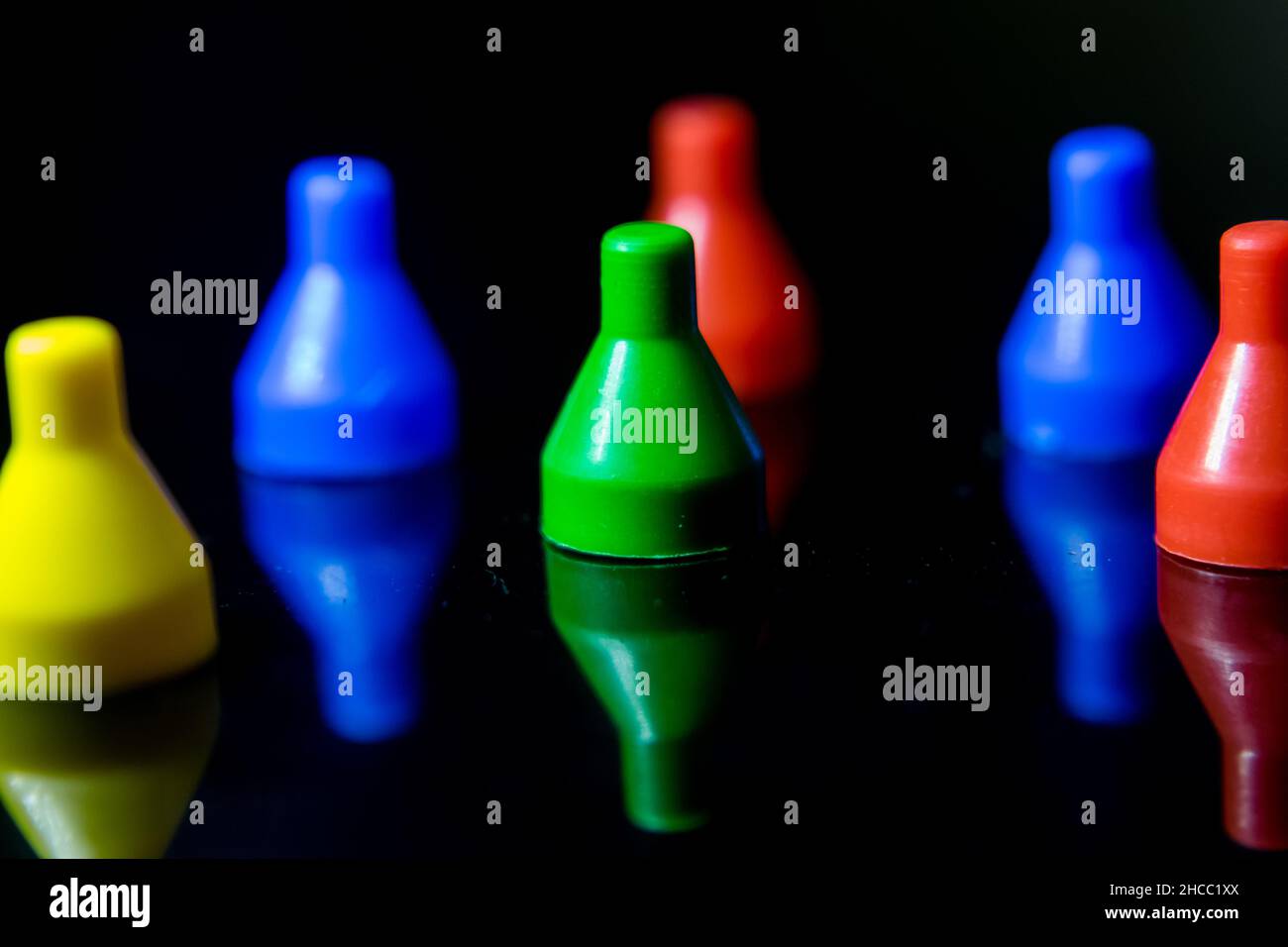 Photo of a some colorful token in a reflective surface Stock Photo - Alamy