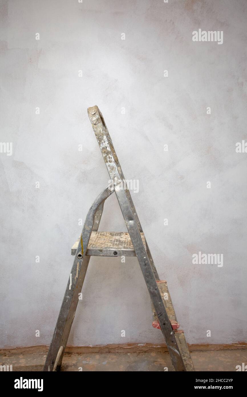 Ladder next to decorated wall Stock Photo - Alamy