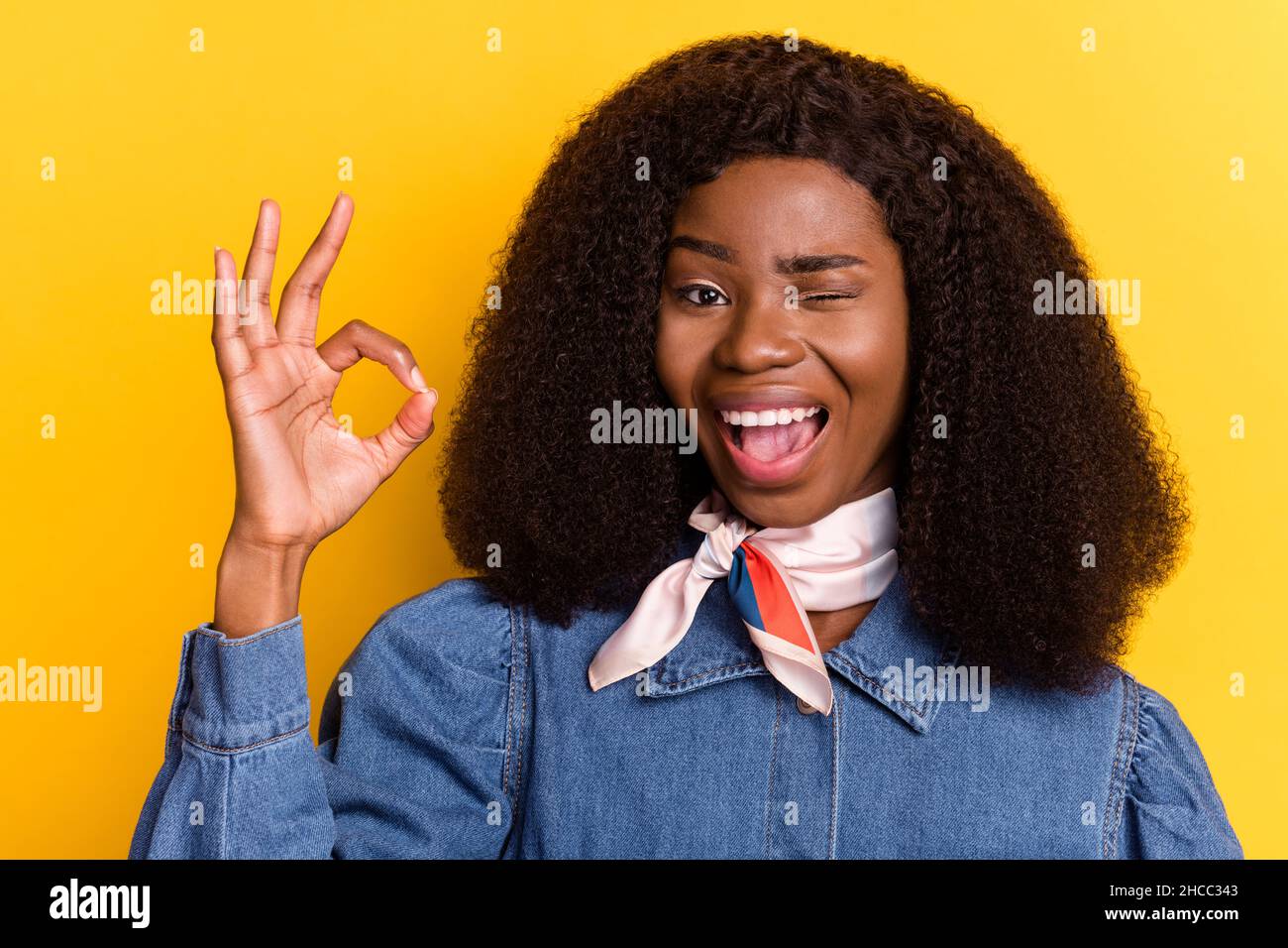 Photo of cheerful funny dark skin person eye wink fingers show okey ...