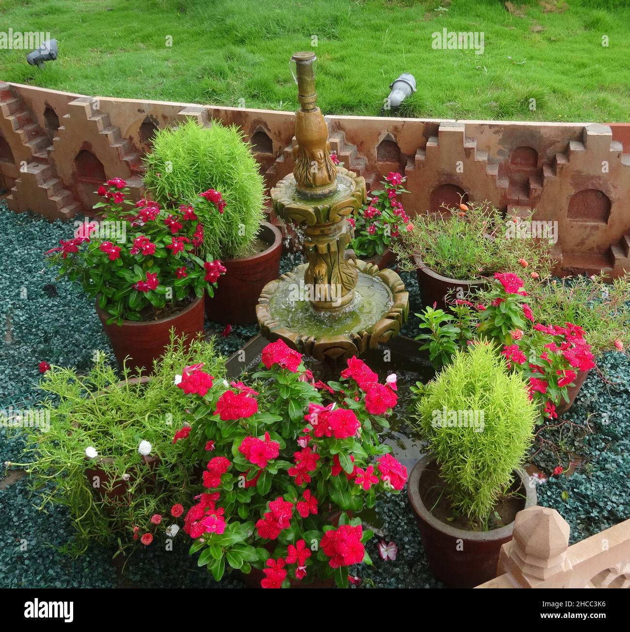 Pink flowers in the flower pots/fountain/garden lawn Stock Photo - Alamy