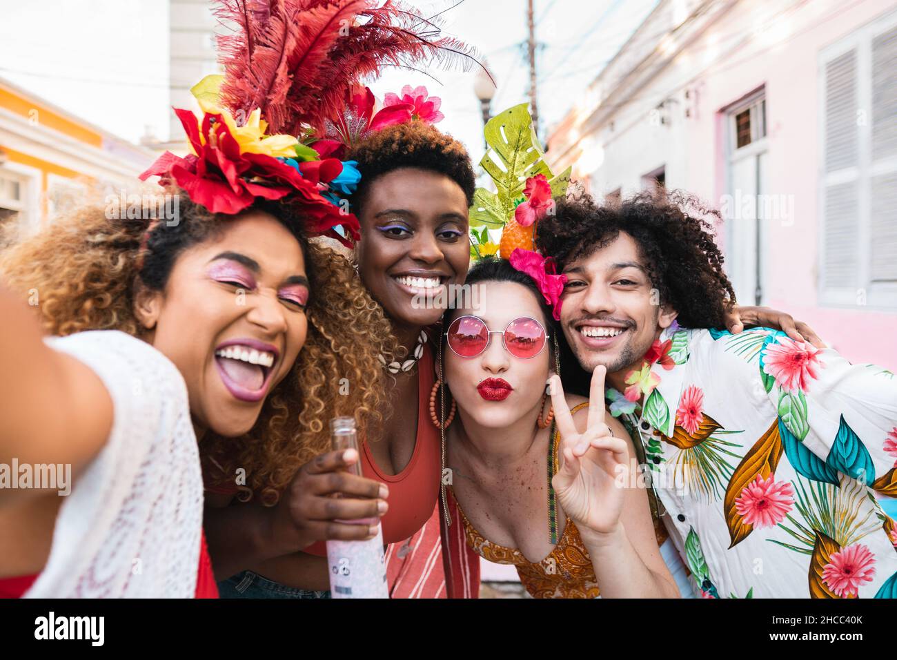 Friends in costumes have fun at carnival party in the street. Brazil ...