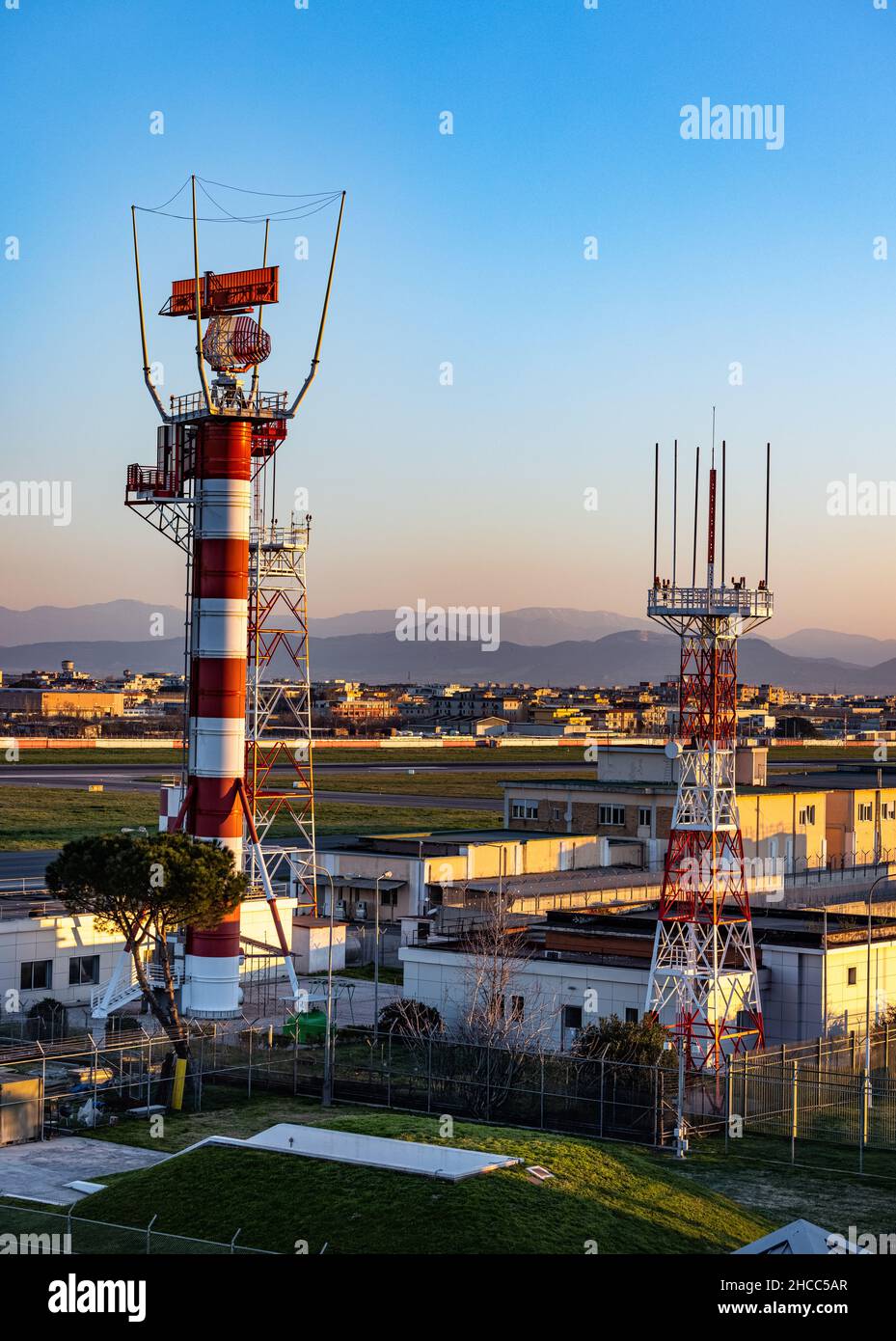 Vertical shot of red white telephone towers in Capodichino, Naples ...