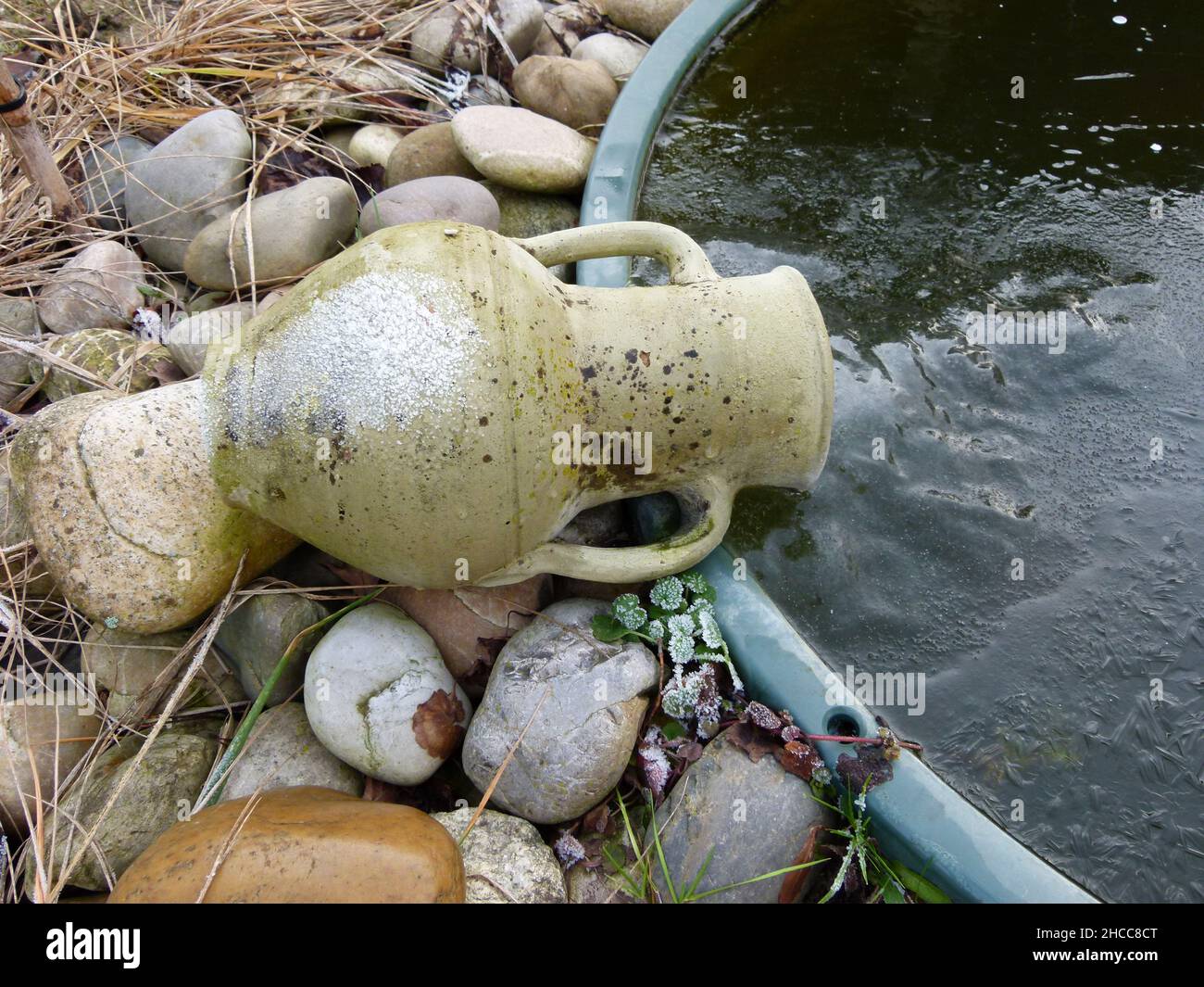 Frozen Small Garden Pond With Amphora And Some Pebbles Stock Photo - Alamy
