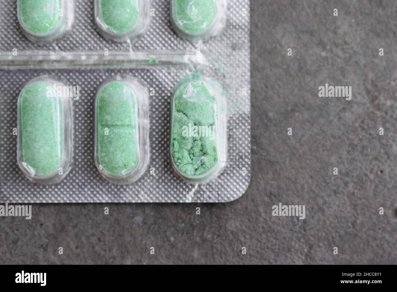 Crushed and damaged tablets in closeup view. Concept of expired drugs ...