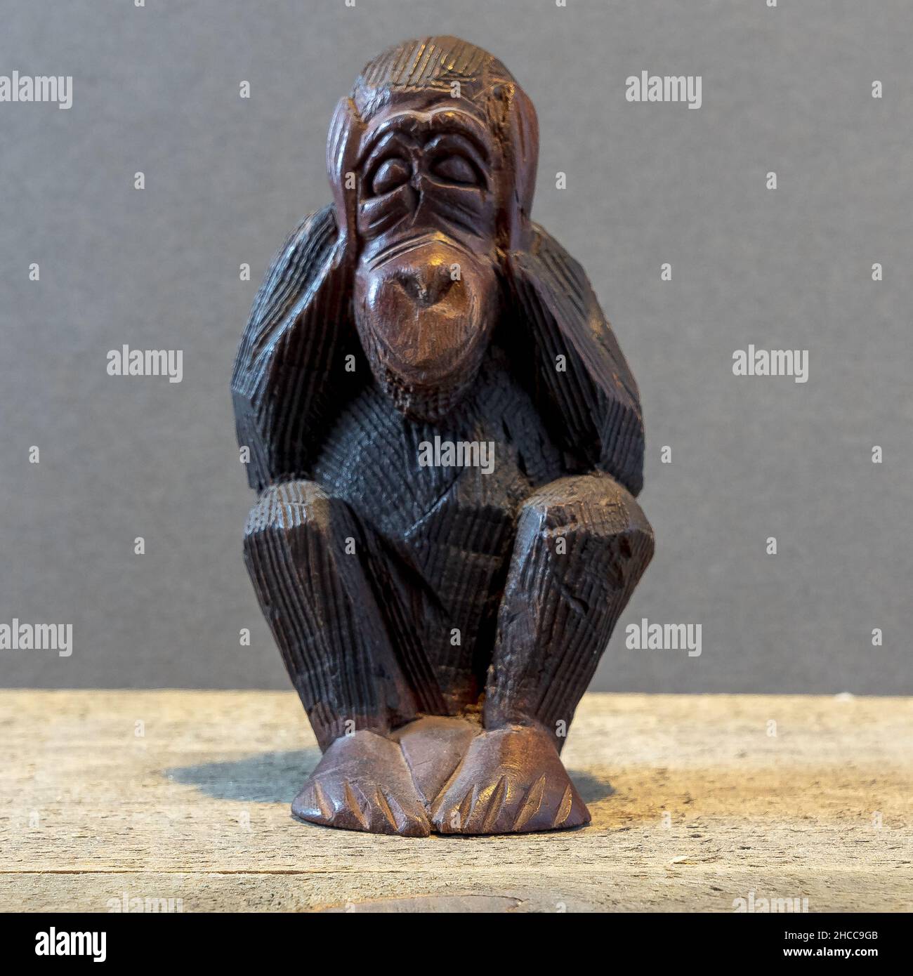 Closeup of a monkey statue covering its ears with hands Stock Photo - Alamy