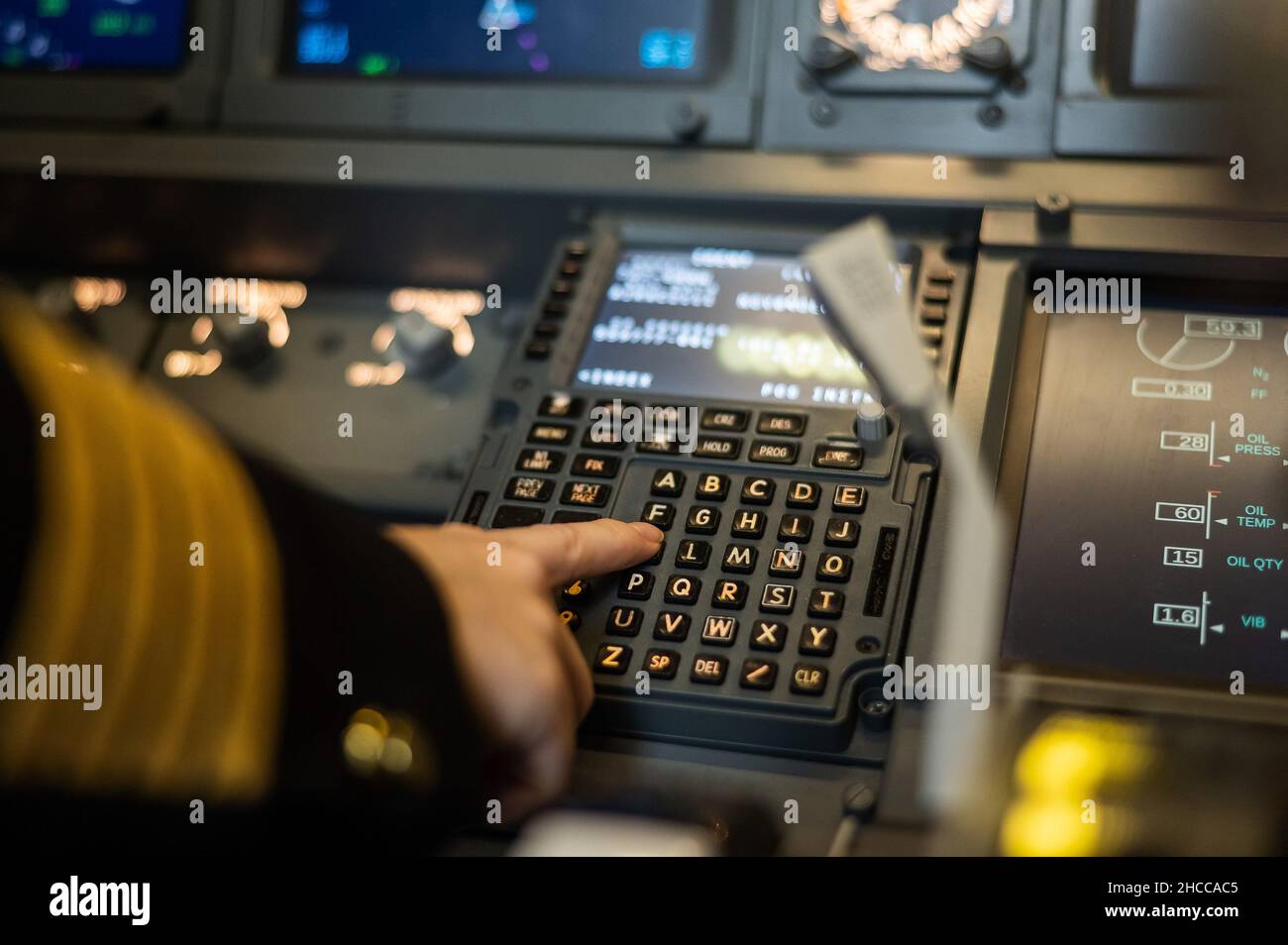 Female pilot inserting flight information into plane system. Airplane ...